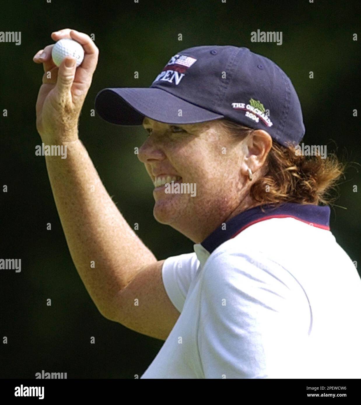 Meg Mallon of Ocean Ridge, Fla. waves the ball after her birdie on the ...