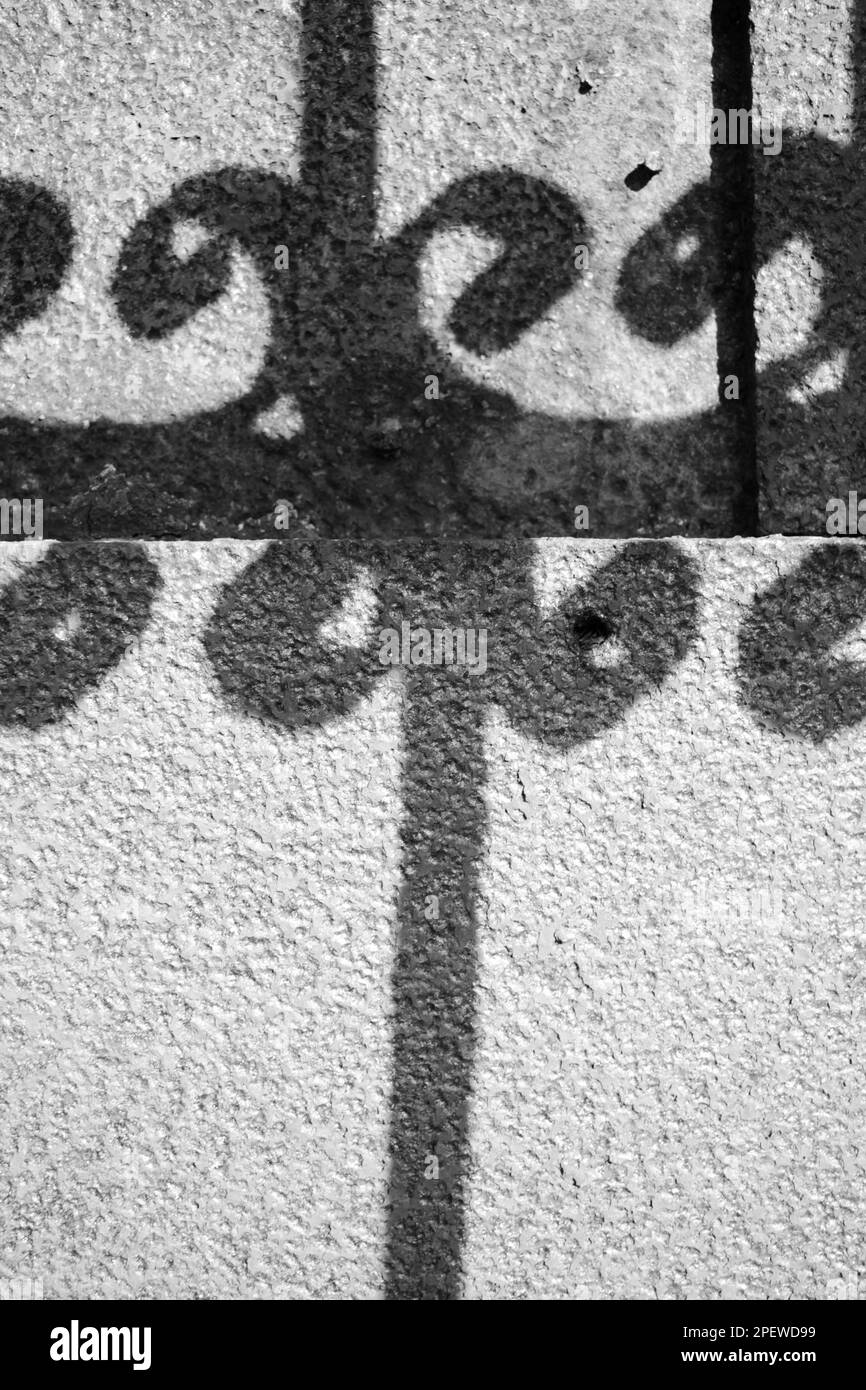 Shadows of the finer details of a medieval fence falling on a vintage ...