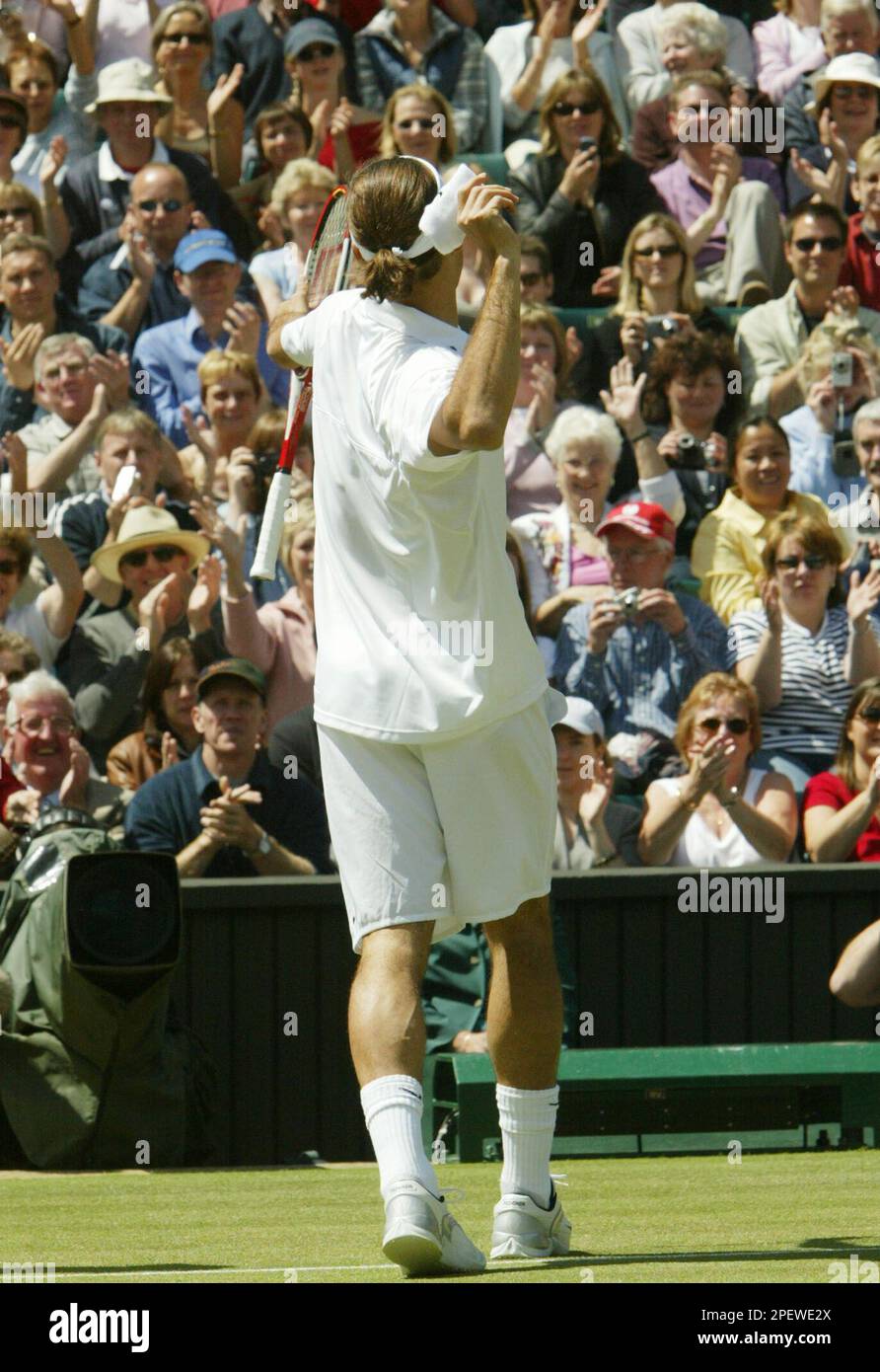 Defending champion Roger Federer throws his wristbands into the crowd ...