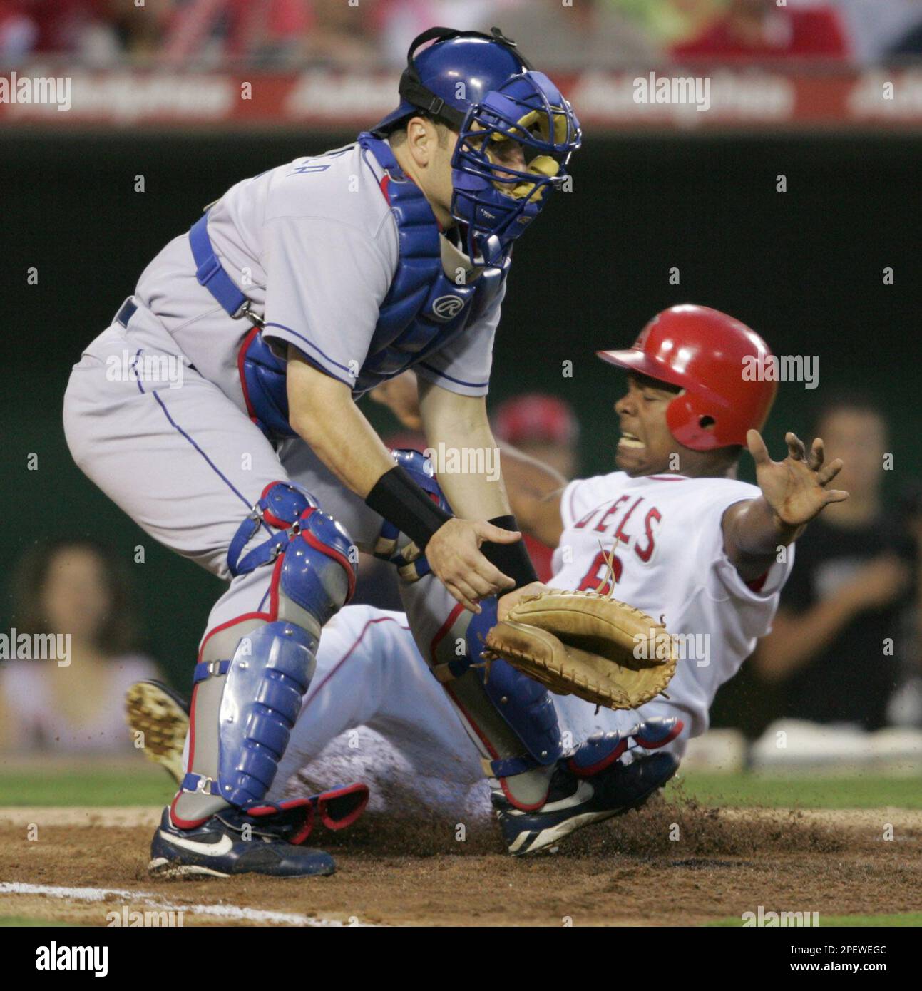 Anaheim Angels' Jose Guillen, right, scores past Los Angeles Dodgers ...