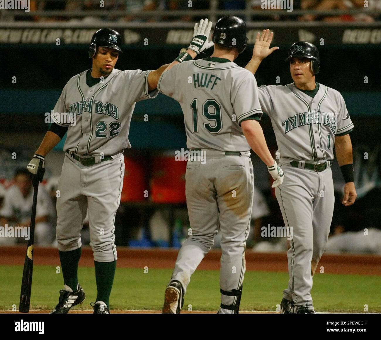 Tampa Bay Devil Rays' Aubrey Huff (19) is congratulated b y teammates ...
