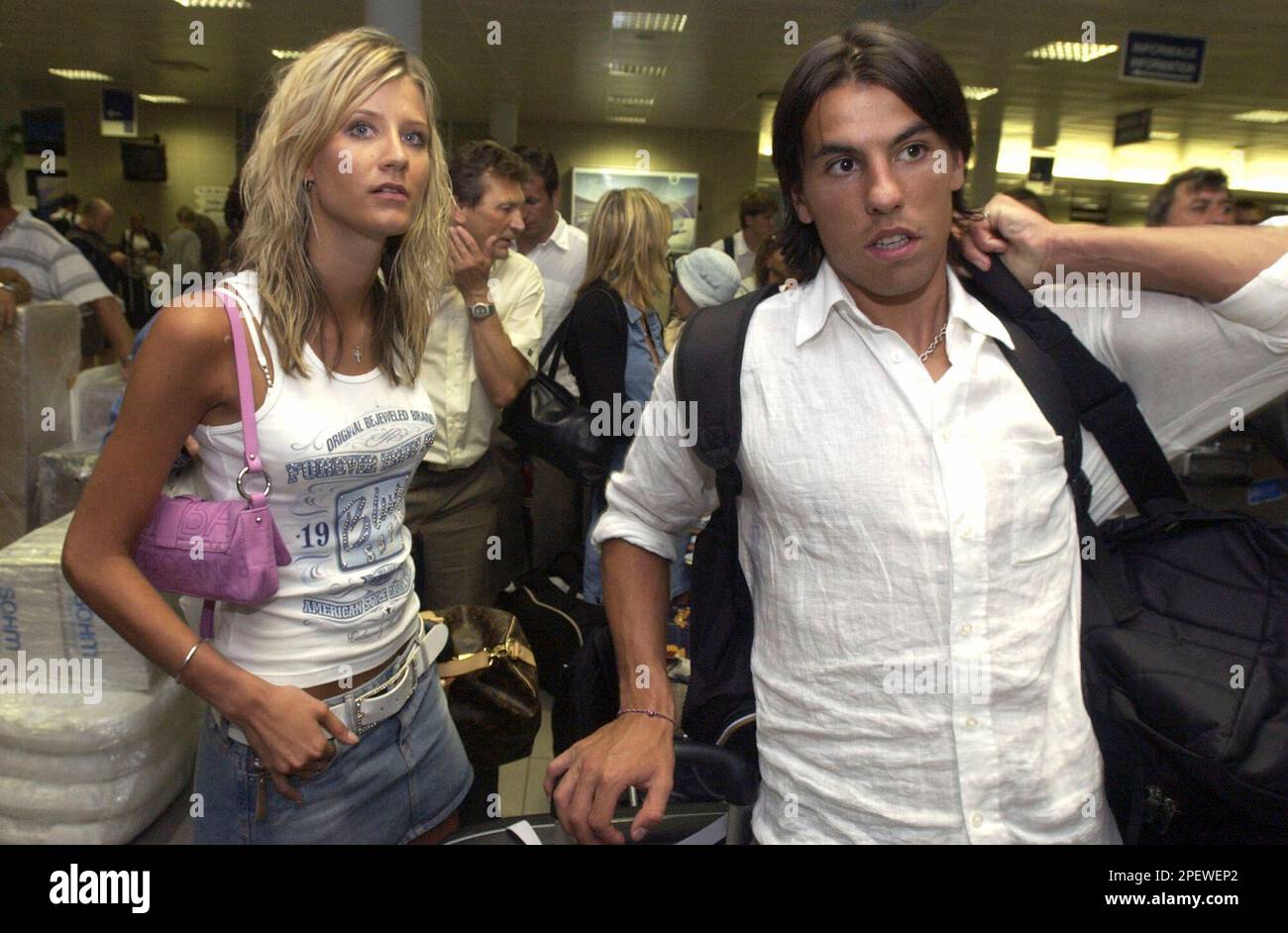 Milan Baros, right, and his girl-friend Eva, left, walk through the ...