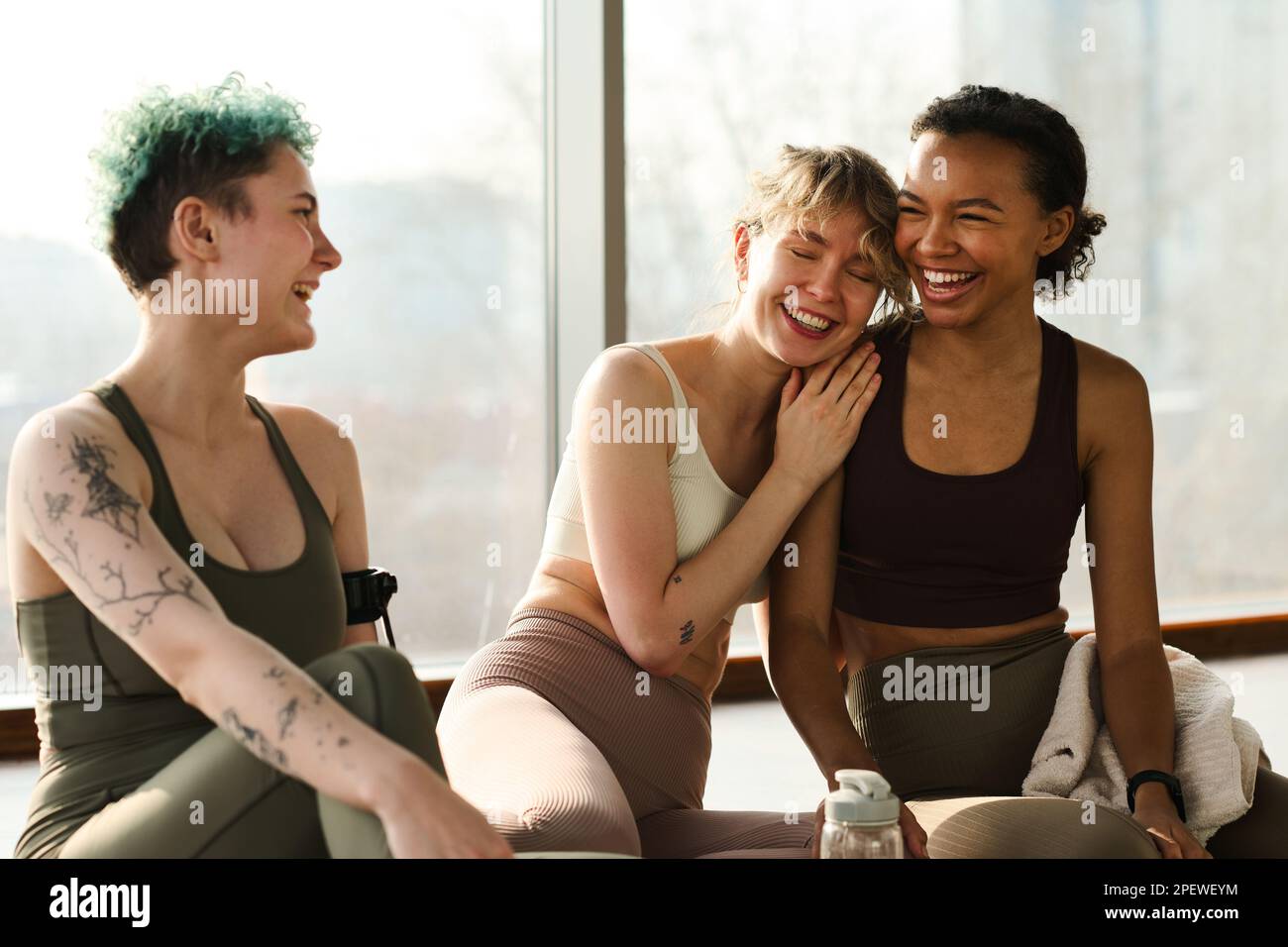 Group of happy girls in sports clothing having fun during sport ...