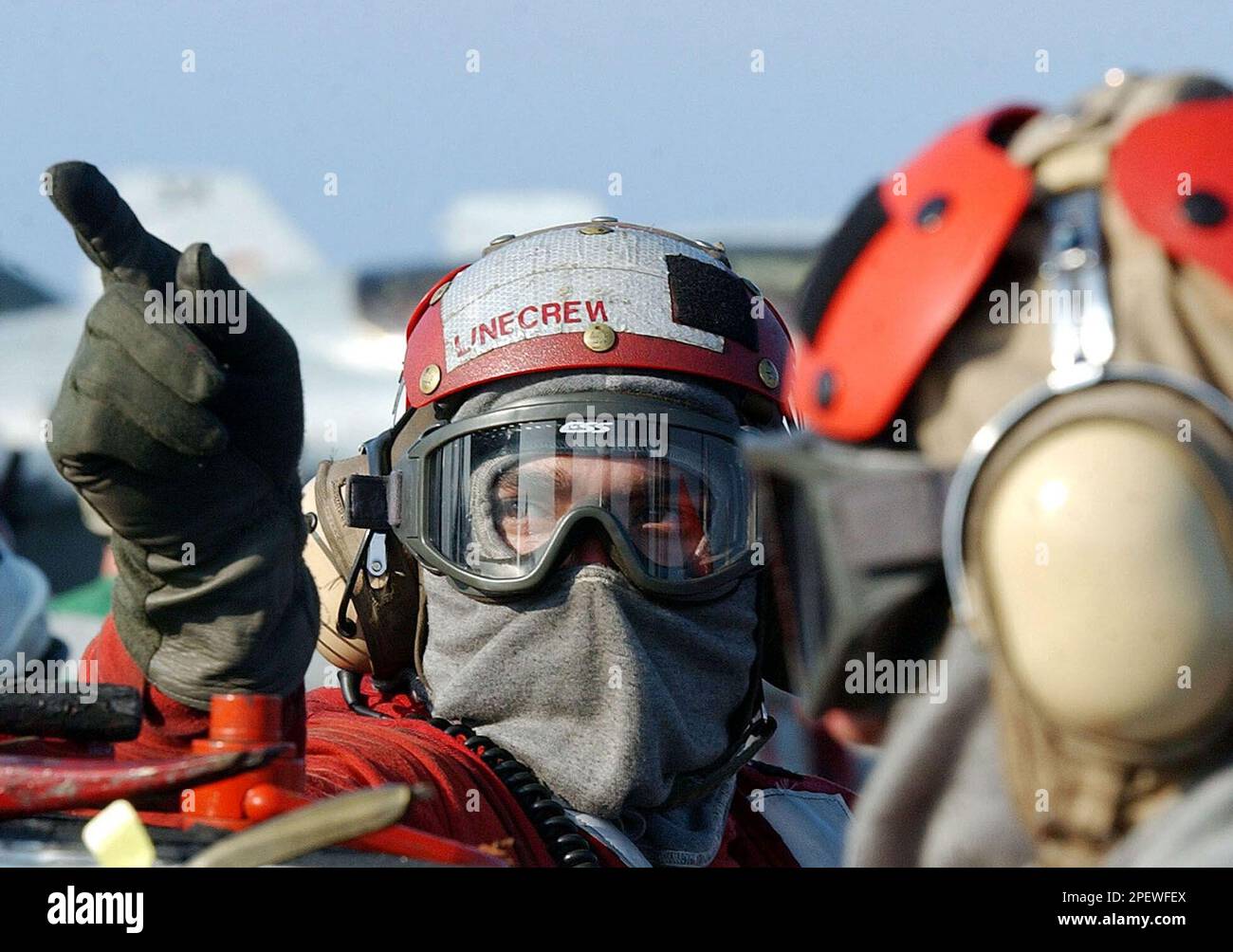 Crash crew personnel talk on the flight deck of the Aircraft Carrier ...