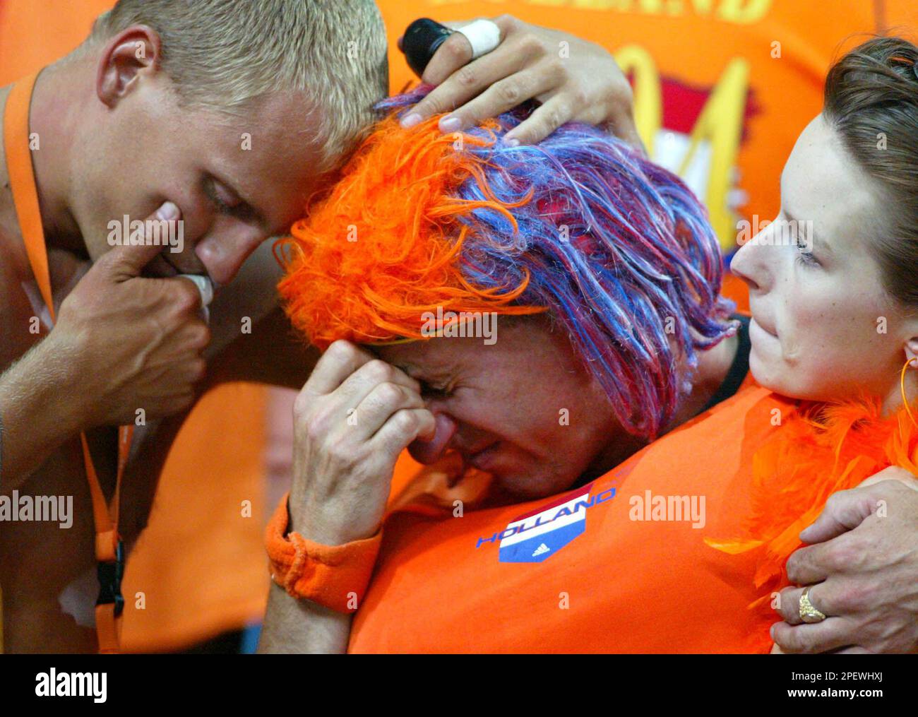 Dutch supporters console each others after Portugal beat the ...