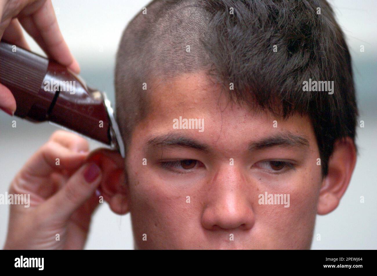 Jacob Rozich, 18, of Altoona, Wis., gets his head shaved during ...
