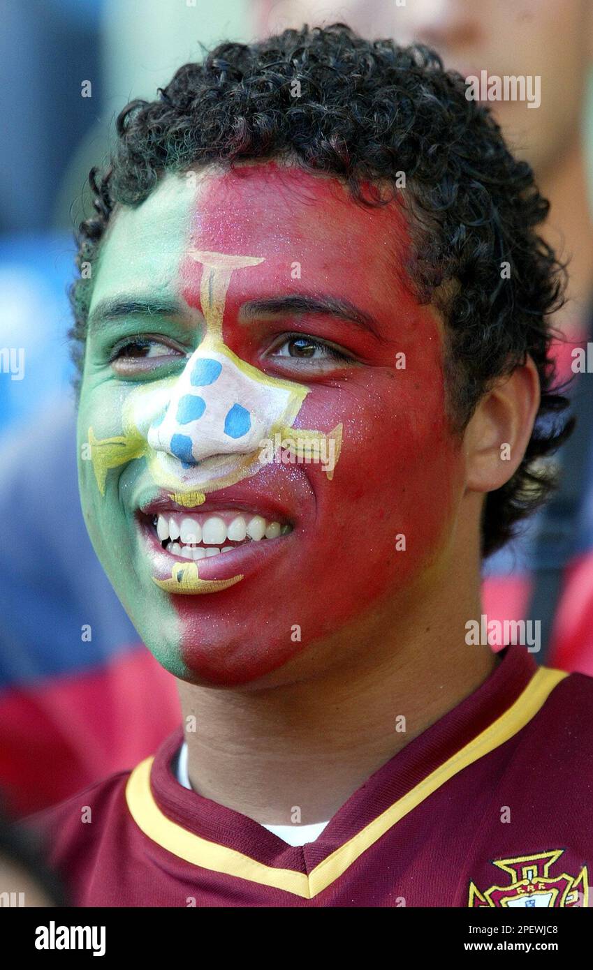 A Portuguese supporter smiles prior to the Euro 2004 semi final soccer ...