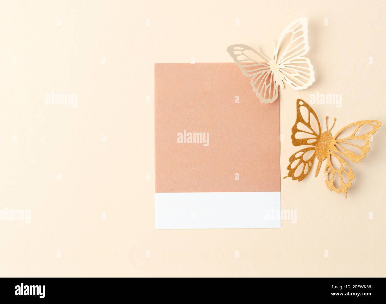 Blank reminder note and carve of paper butterfly on yellow background ...