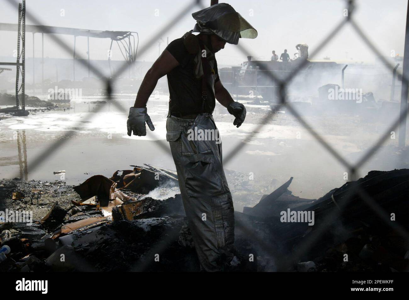A U.S. Army soldier surveys the damage after a mortar attack wounded 11 ...