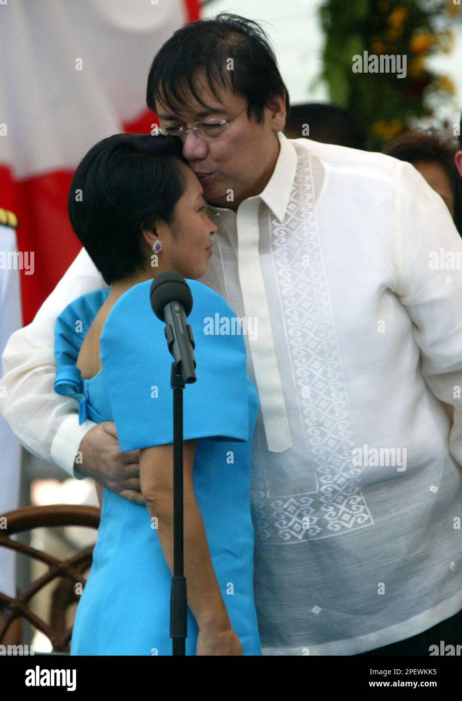 Philippine President Gloria Macapagal Arroyo is kissed by her husband ...