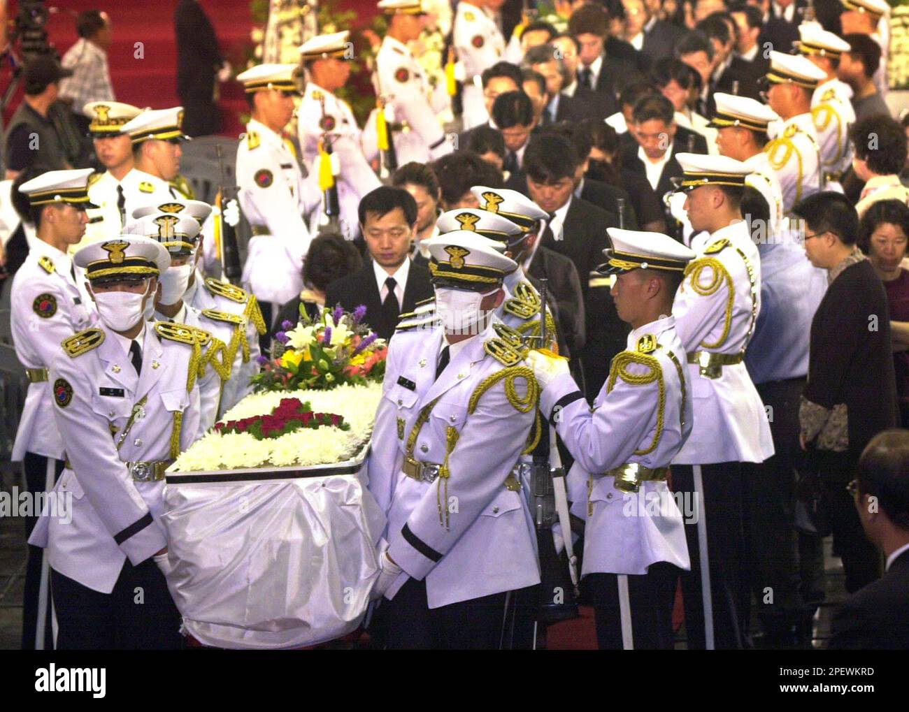 Police honor guards carry the coffin containing the body of South ...