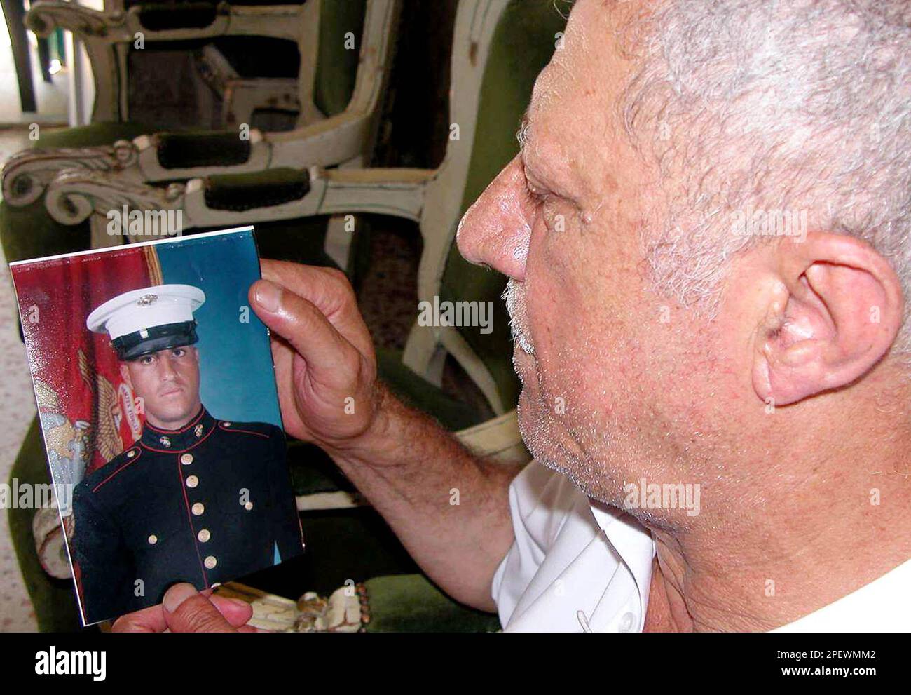 Ali Hassoun holds picture of his son at his house in the northern ...