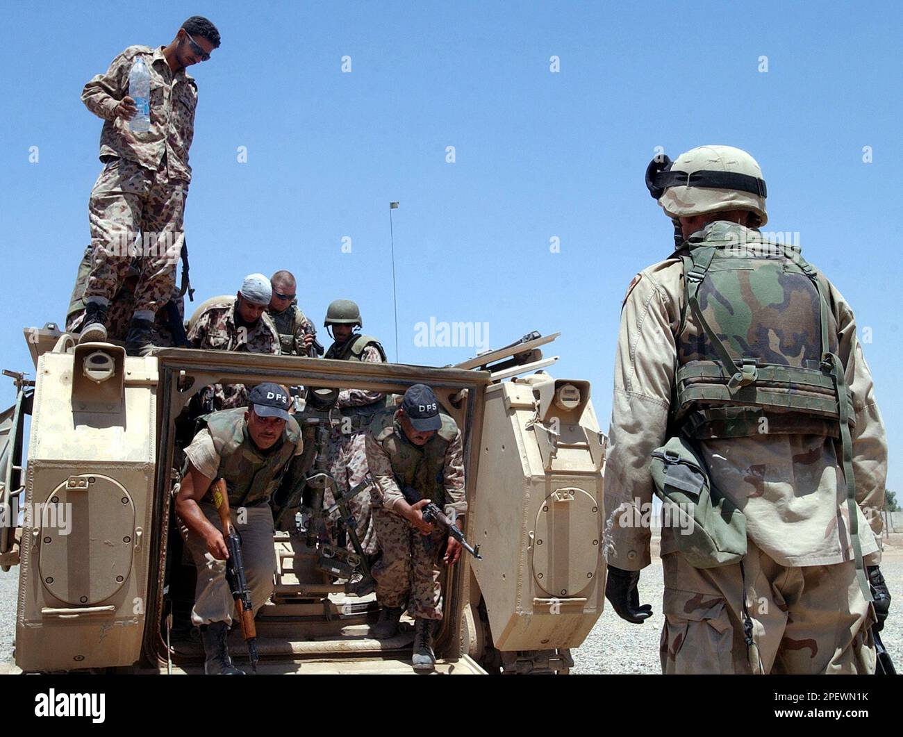 A U.S. Army soldier and members of the Iraqi Civil Defense Corps, (ICDC ...