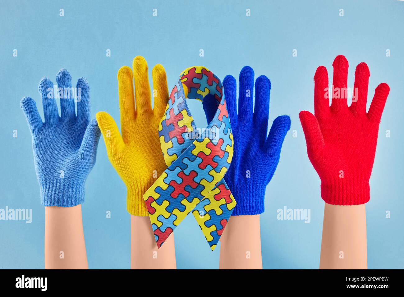 Hands holding puzzle ribbon for World Autism Awareness Day Stock Photo ...