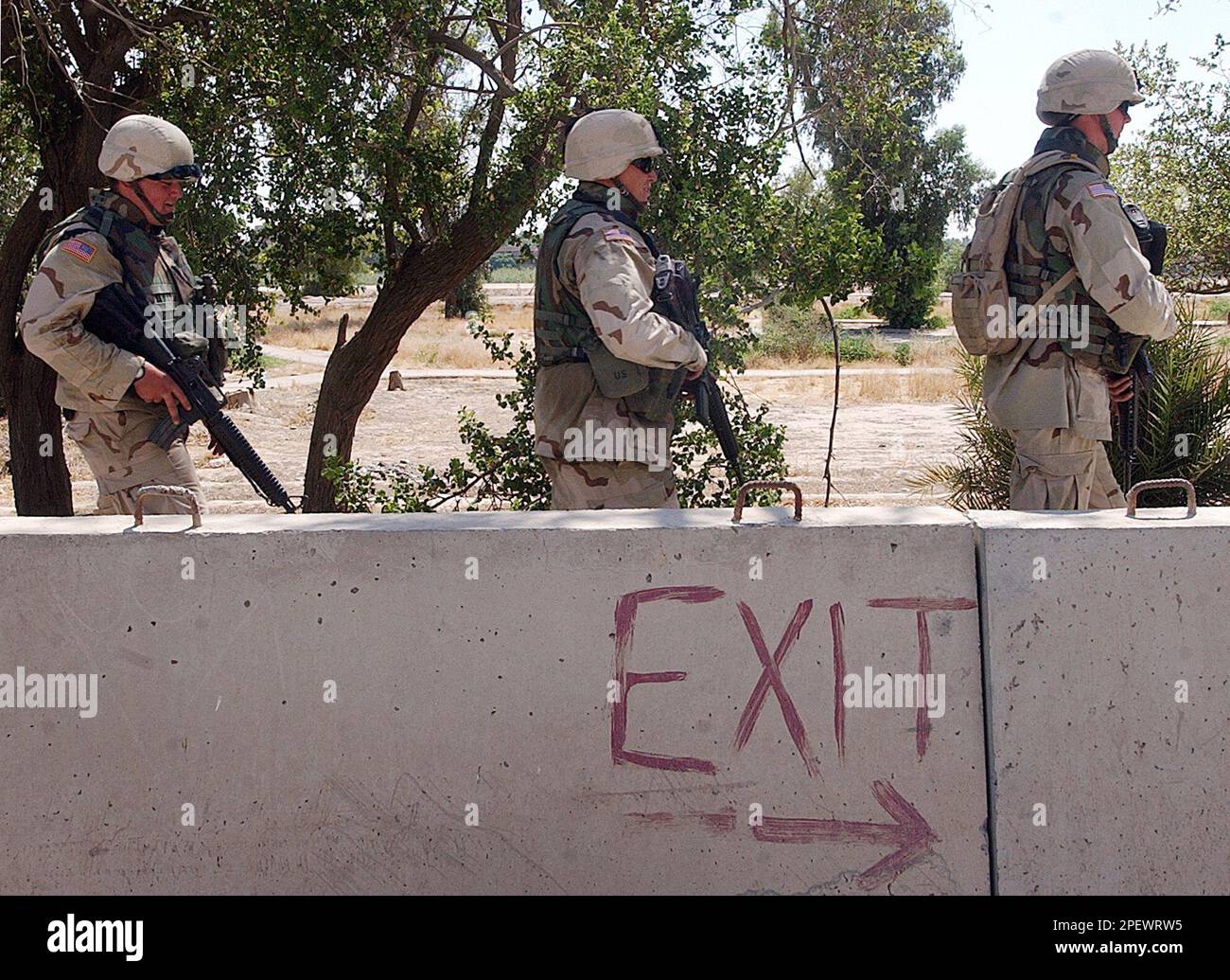 American Army soldiers walk through the streets of Baghdad near a ...