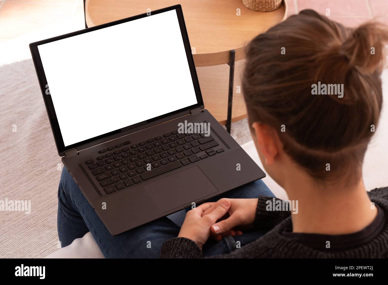 High angle of anonymous male patient with ponytail sitting on sofa and ...