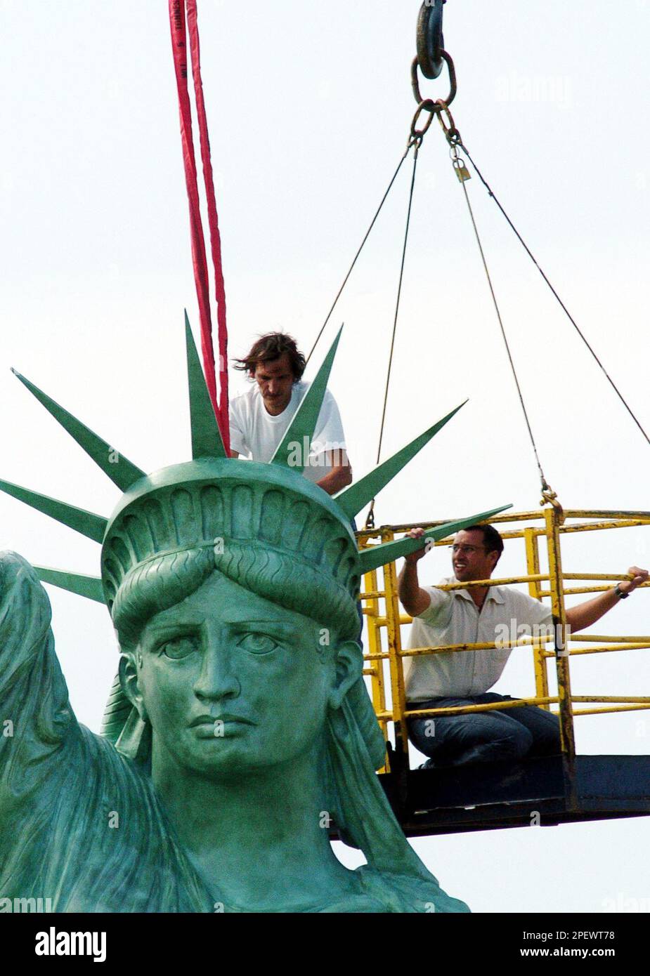 Workers of Colmar, eastern France, work at a replica of the Statue of ...