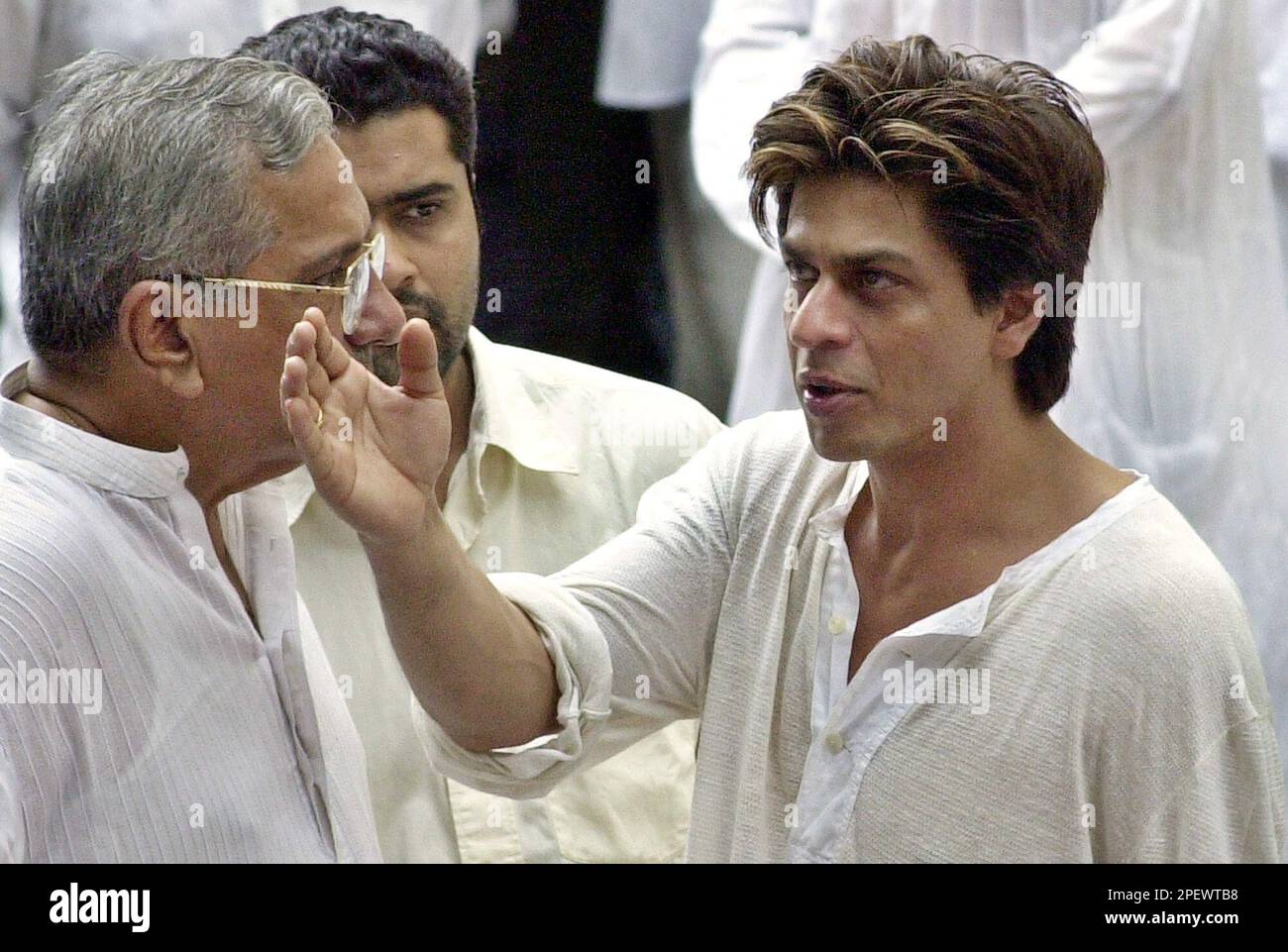 Bollywood actore Shahrukh Khan, right, speaks with his friends during ...