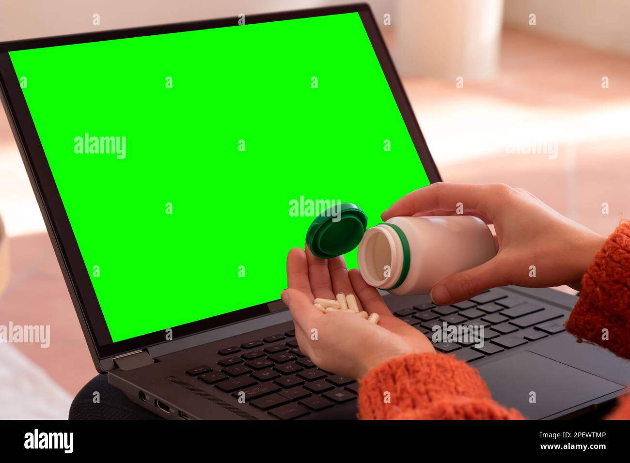 Unrecognizable female patient with plastic container of pills and ...