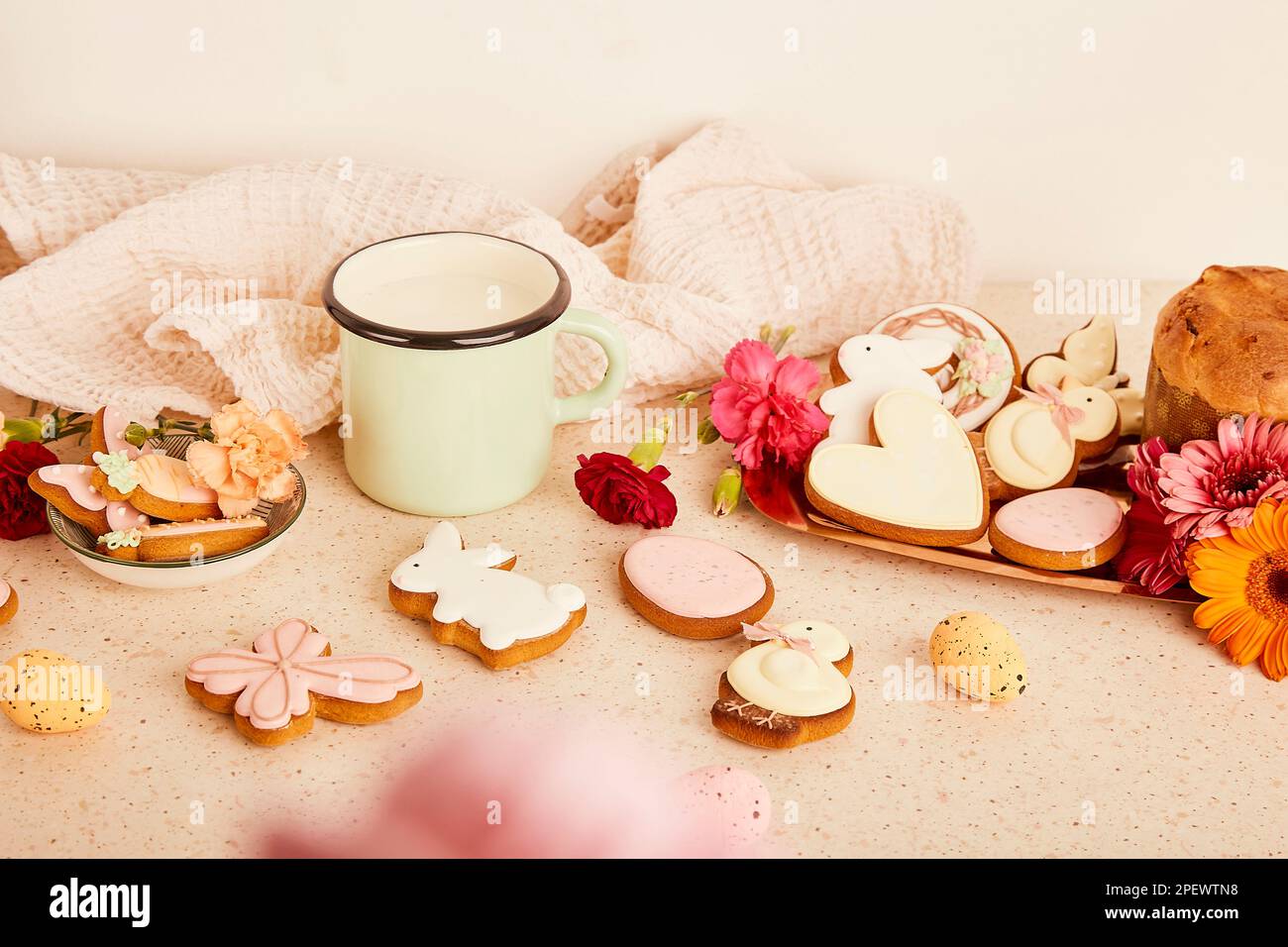 Cozy Easter lifestyle background. Table with mug of milk among glazed ...