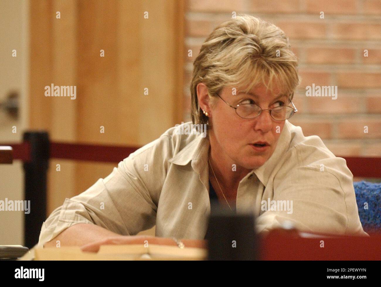 Donna Somerville looks to the courtroom clock as she replies to a ...