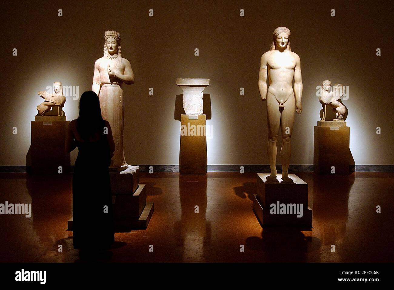 A visitor admires ancient Greek statues at Athens' National ...