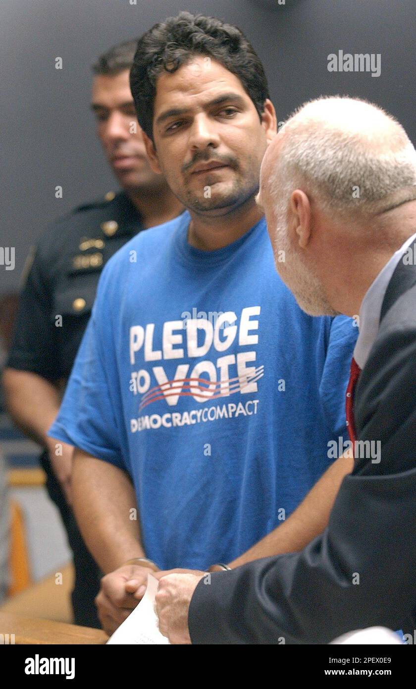 Angel Navarro, wearing blue shirt, is shown during his arraignment ...