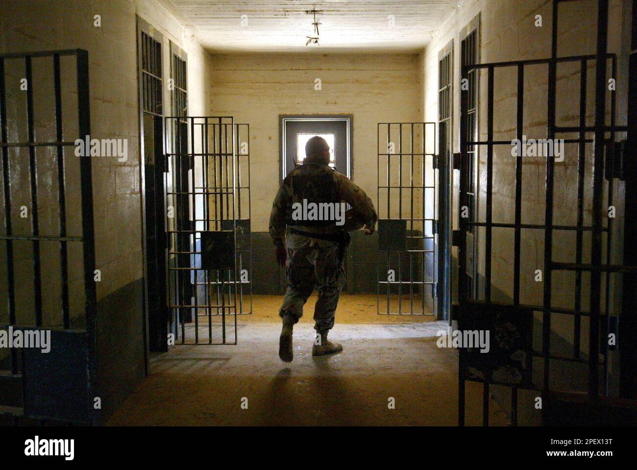 U.S. Army military police Maj. Gary Link walks through "death row" used ...