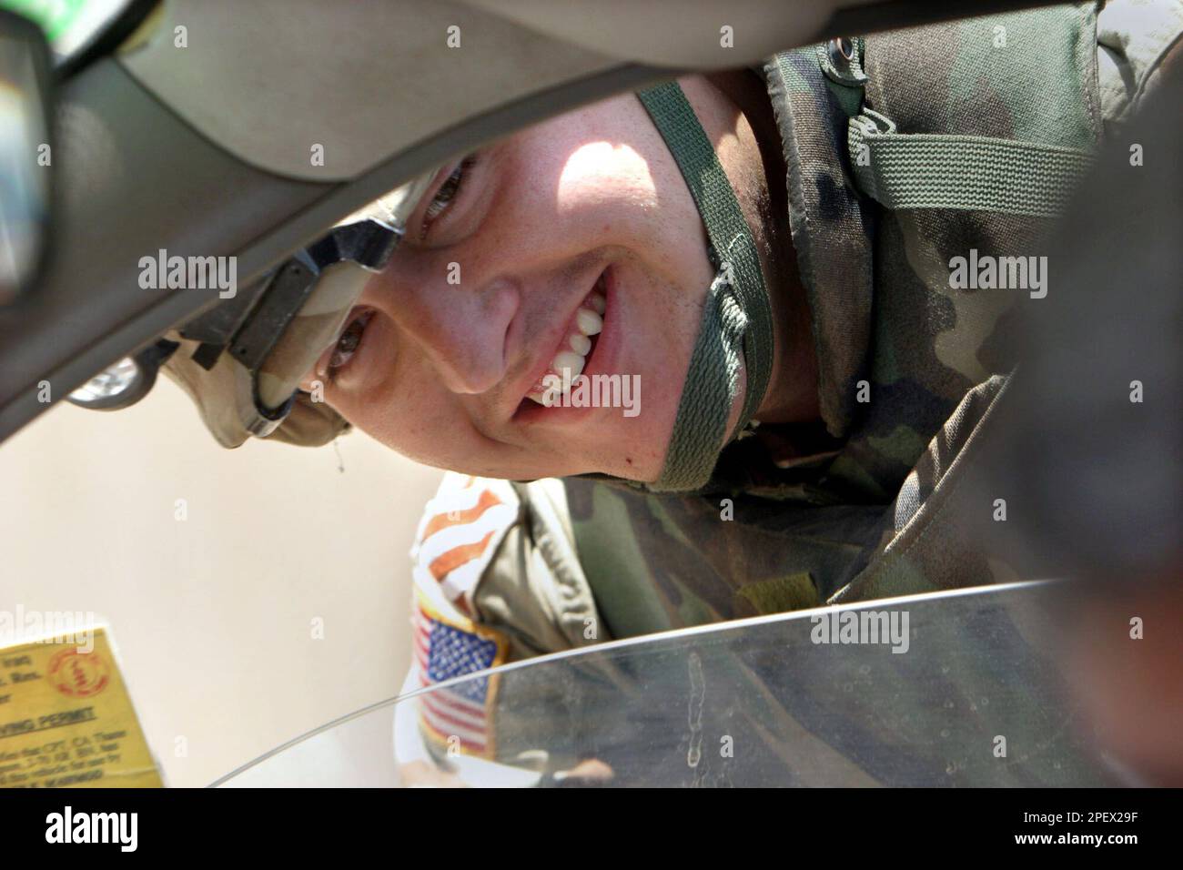 U.S. Army Spc. Donald Nuss, of Brookings, Oregon, greets a driver at a ...