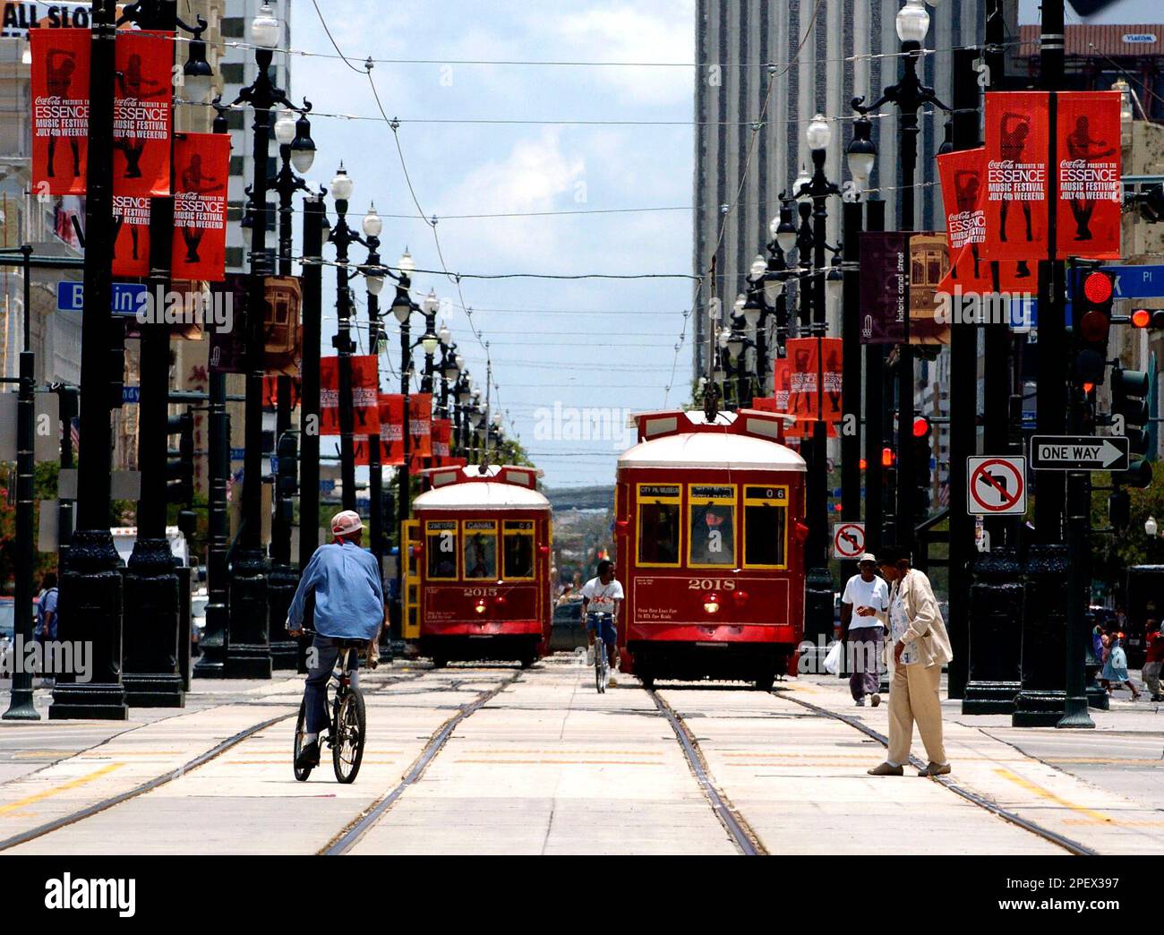 Two of the new streetcars move along Canal Street in the central ...