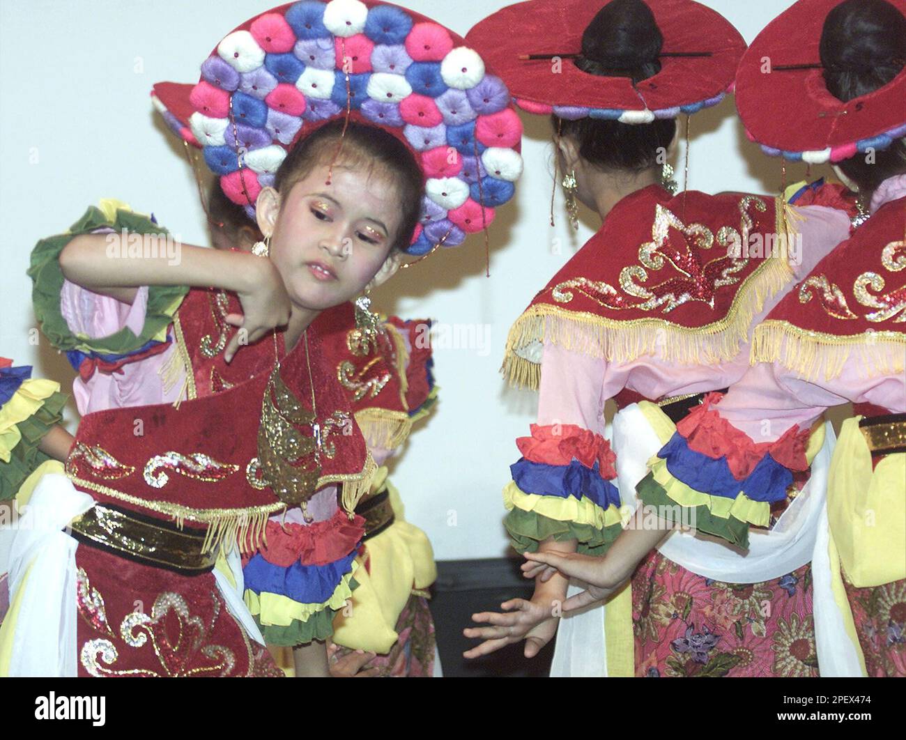 Young girls perform a traditional Betawi dance at a cultural festival ...
