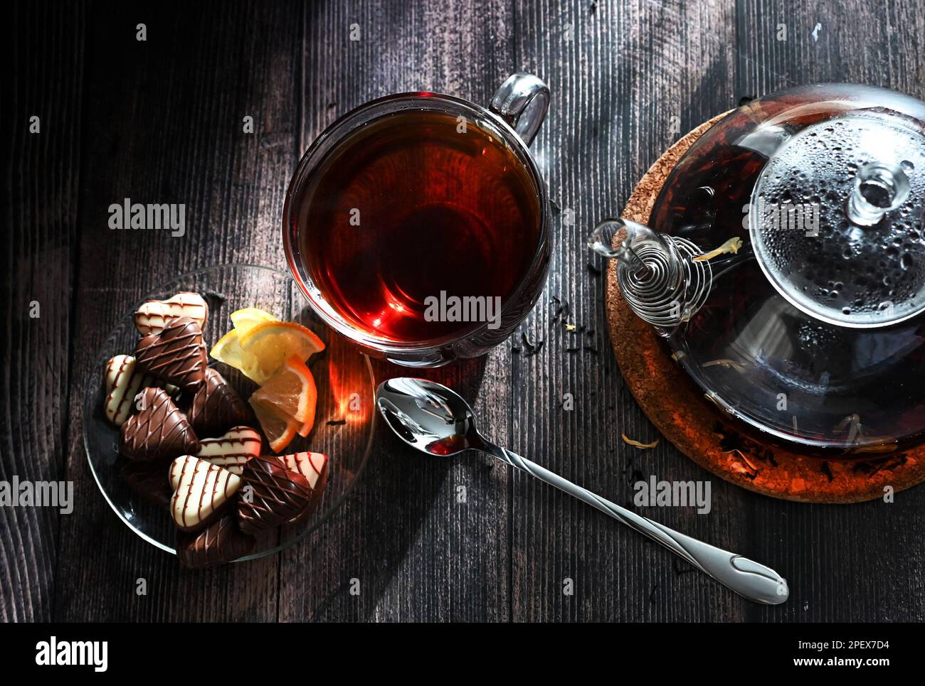 A woman's hand pouring tea into a mug. Steamed tea, morning tea, home ...
