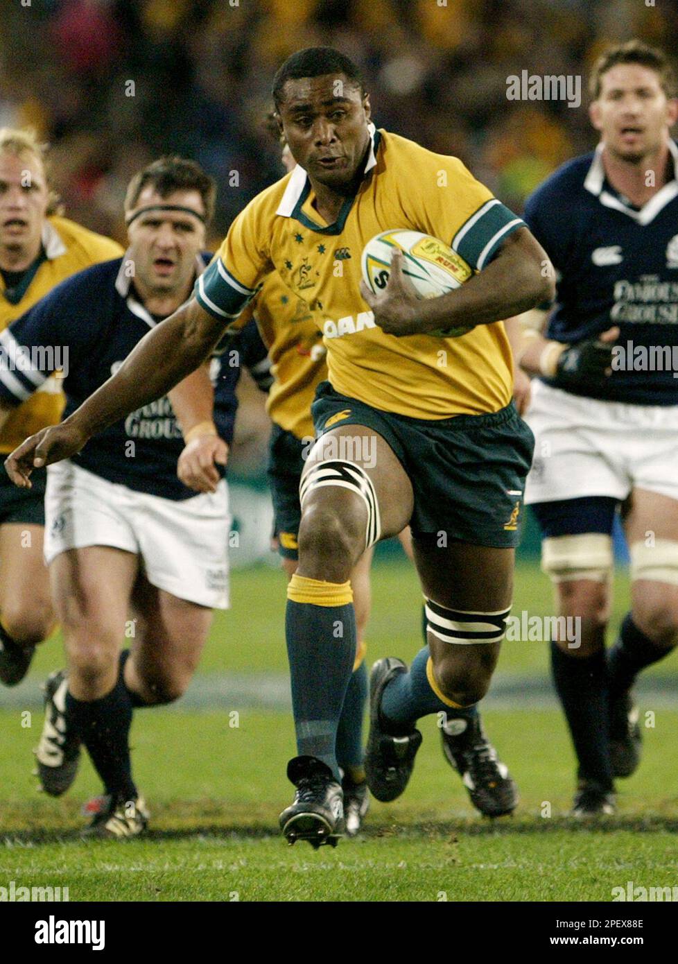 Australia's Radike Samo, center, races past Scotland's players during ...