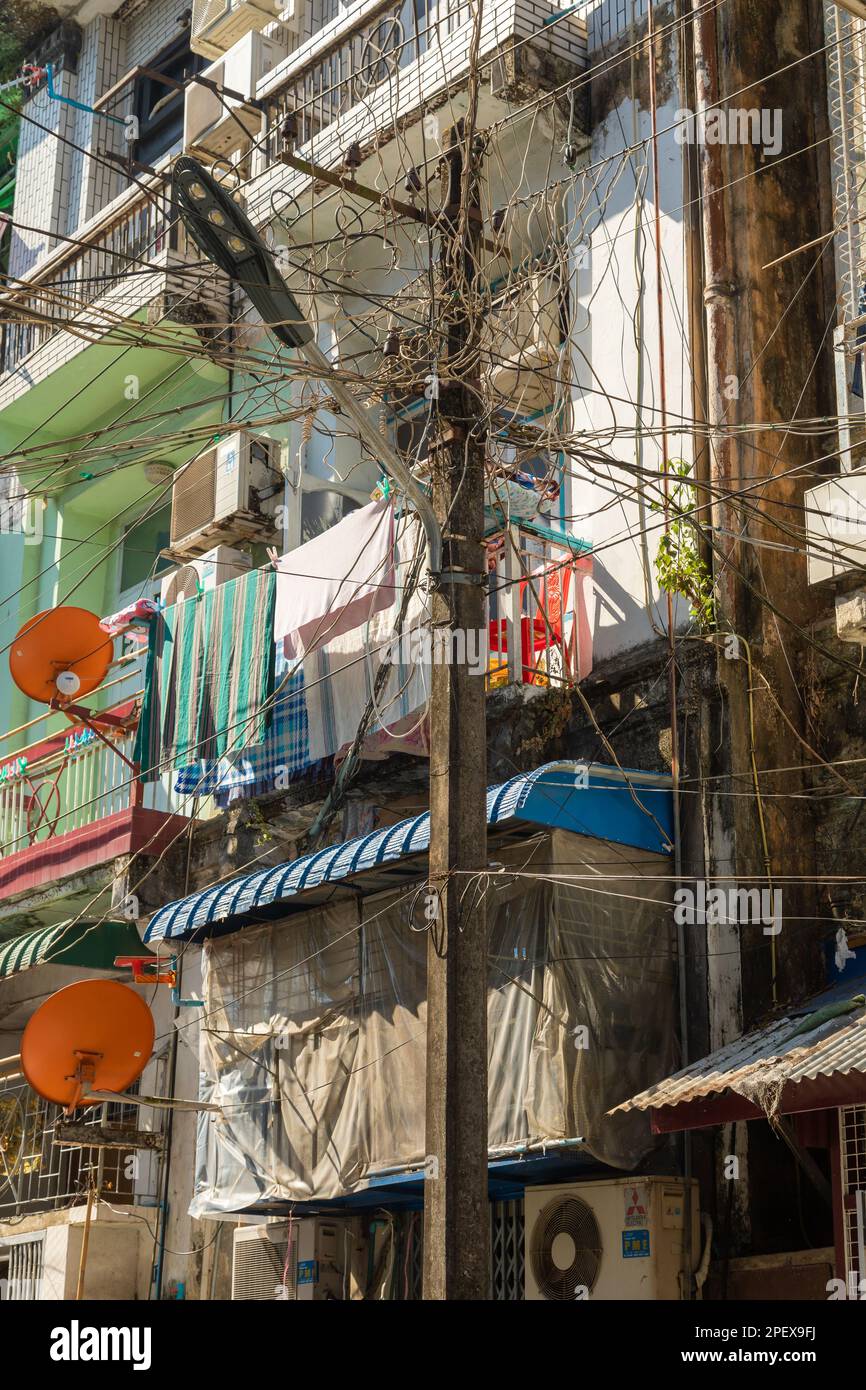 Yangon, Myanmar - Dec 19, 2019: An electrical pole, tangled with ...