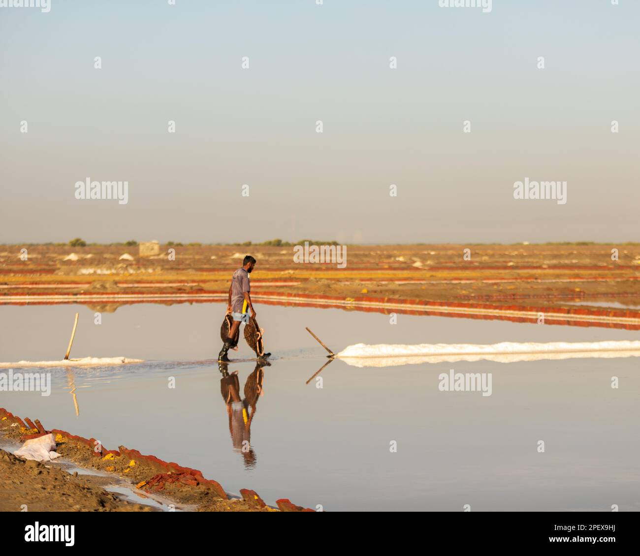 Bhambore Sindh Pakistan 2022, Labor collecting and stacking sea salt at ...