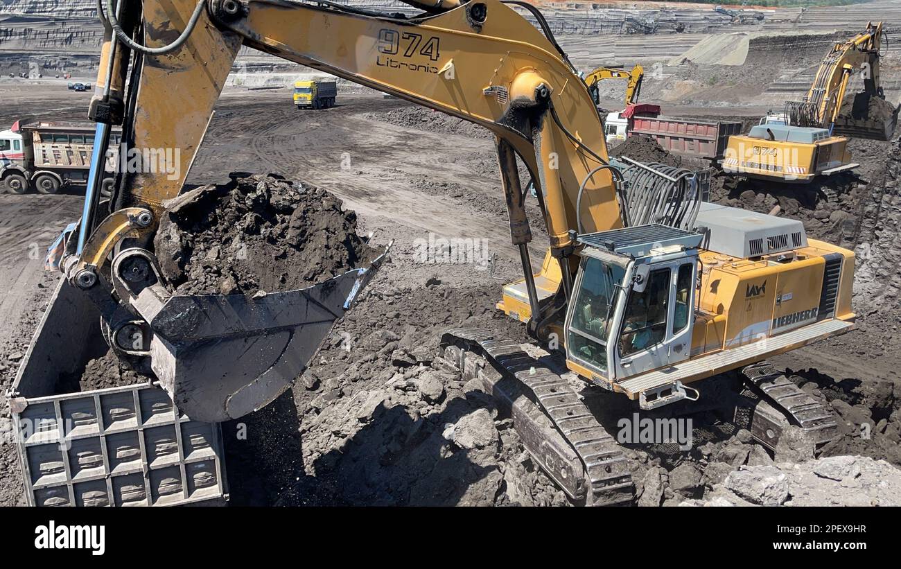 Excavators Working On Huge Mining Site, Loading The Trucks, Trucks ...