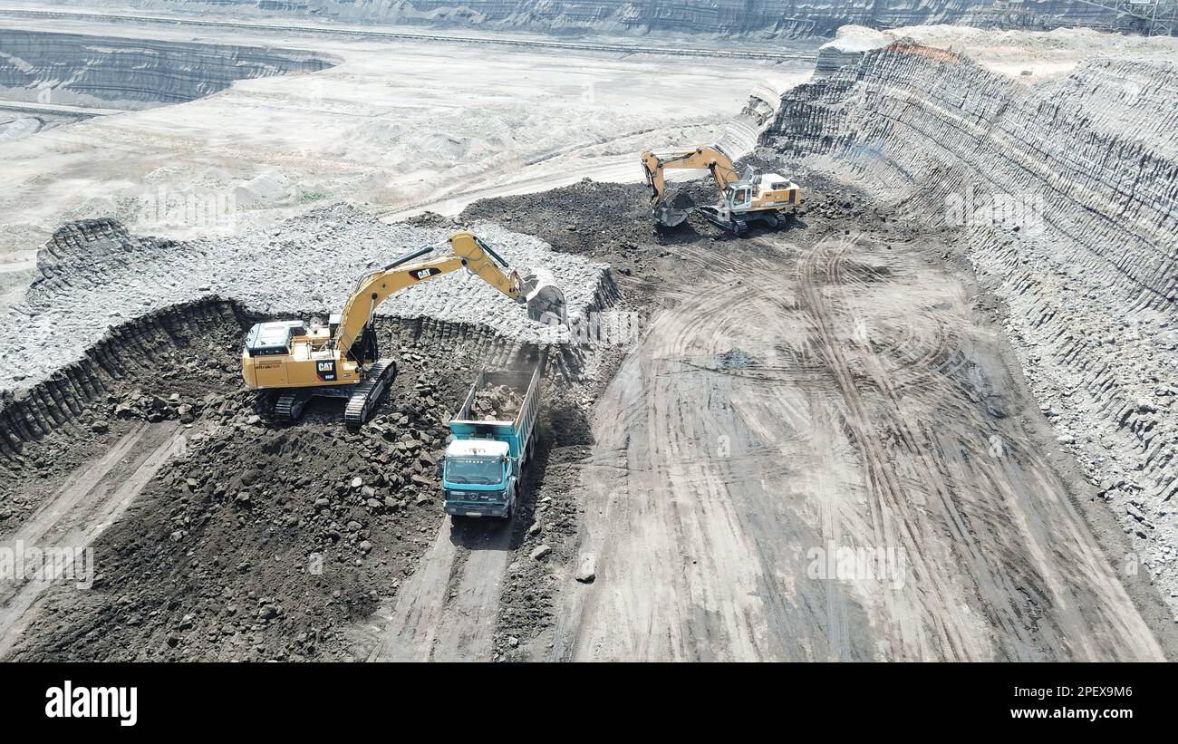 Excavators Working On Huge Mining Site, Loading The Trucks, Trucks ...