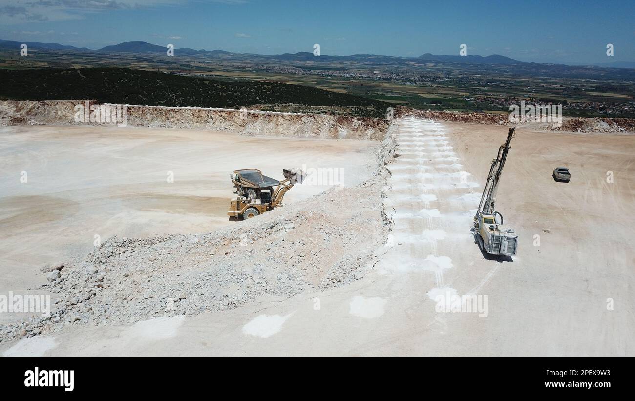 Wheel Loader loading coal on trucks, working at a huge mining site ...