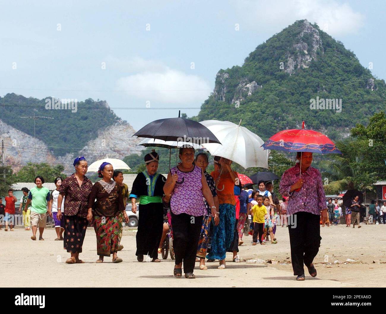Hmong refugees walk on the ground of Wat Tham Krabok Buddhist temple in ...