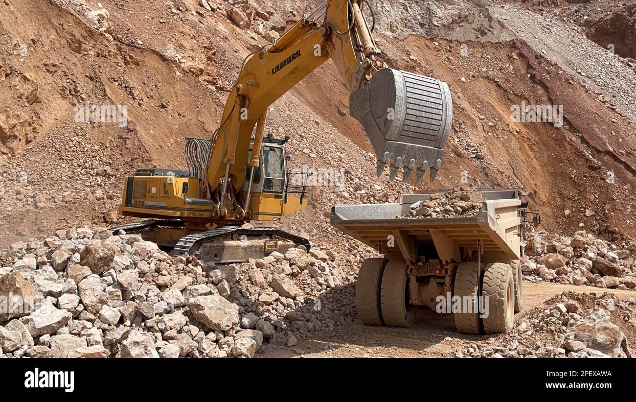 Excavator Working On Huge Mining Site, Loading The Trucks, Trucks ...