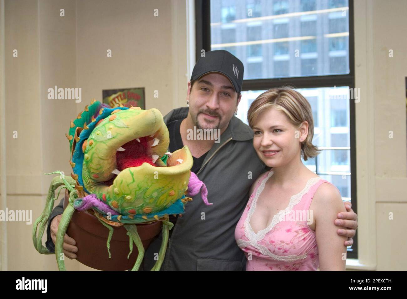 Pop singing group member Joey Fatone poses with the man-eating plant ...