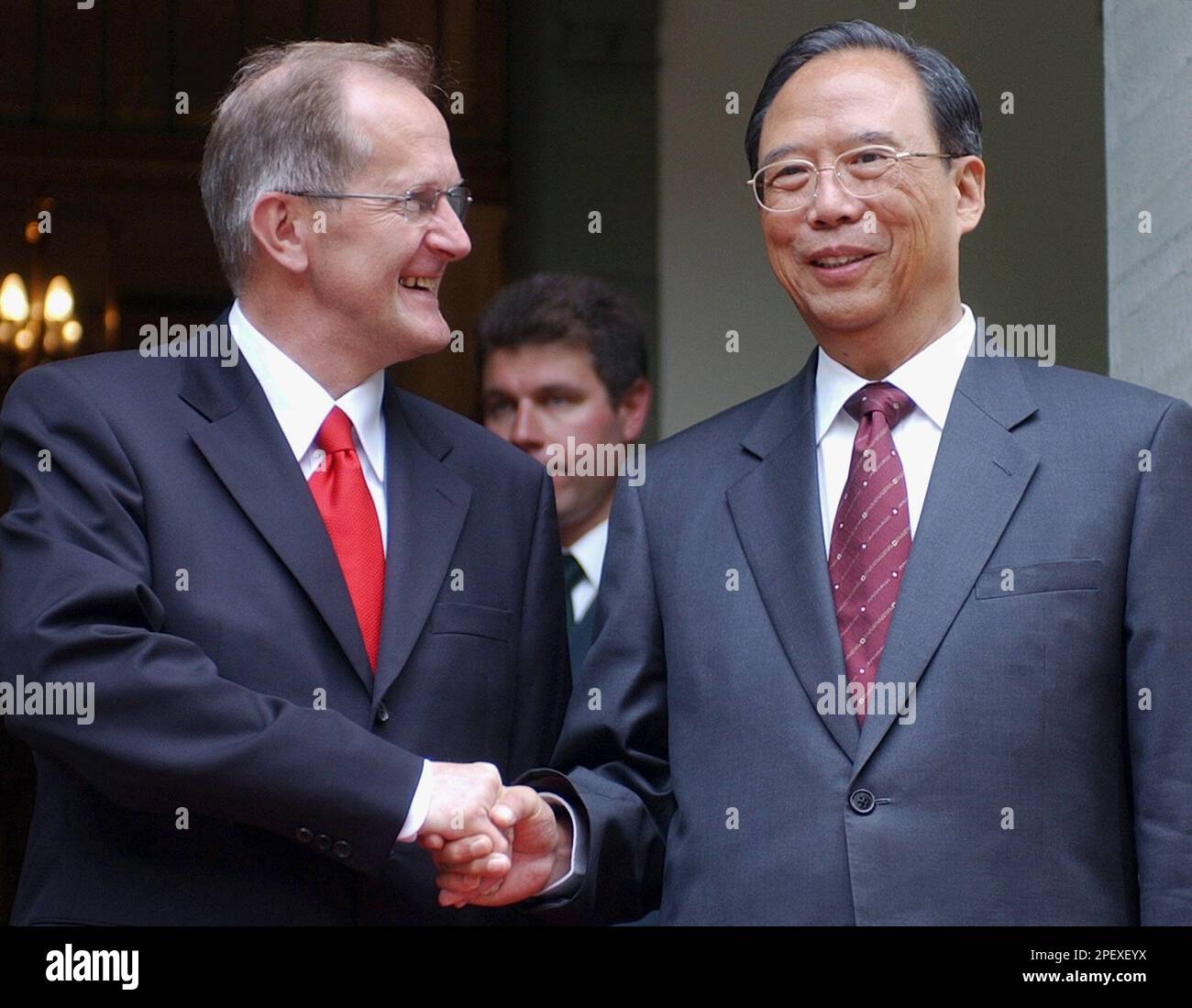 Swiss President Joseph Deiss, left, shakes hands with Chinese deputy ...