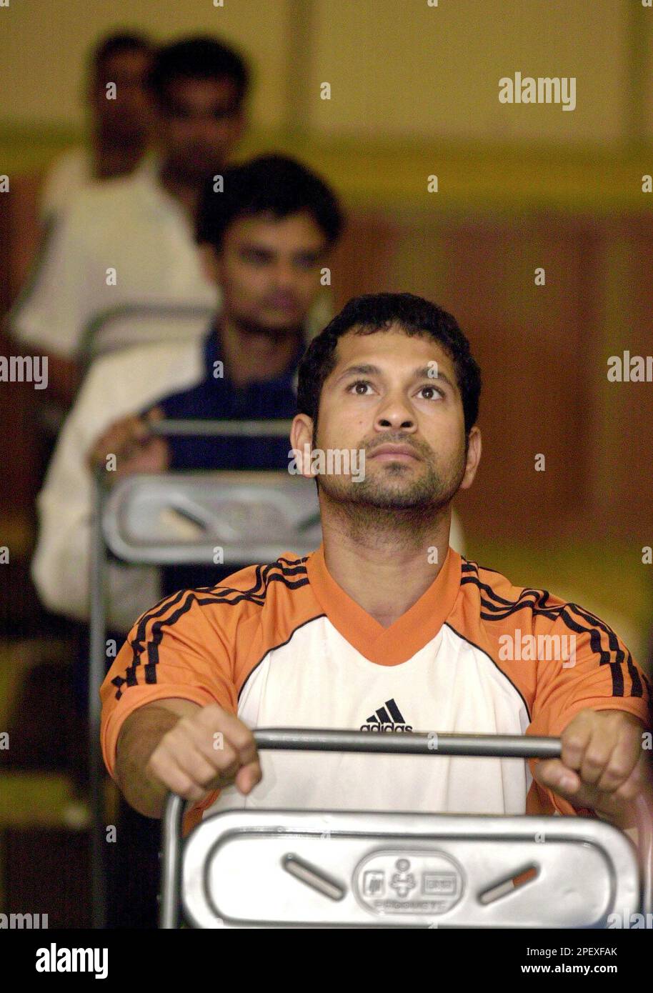 Indian cricketer Sachin Tendulkar performs a posture along with other ...
