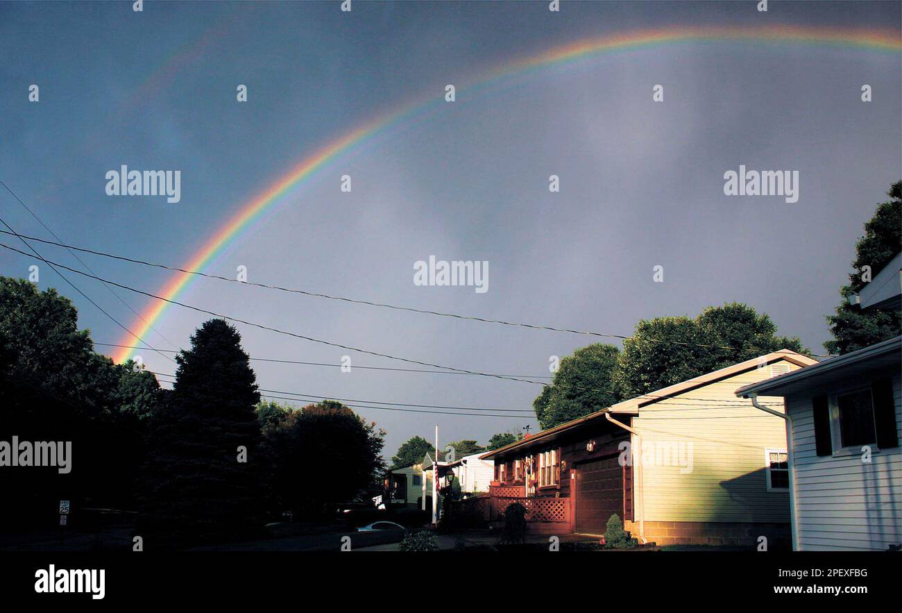 A rainbow forms over in Salem, Ohio, Monday, June 14,2004, after a ...