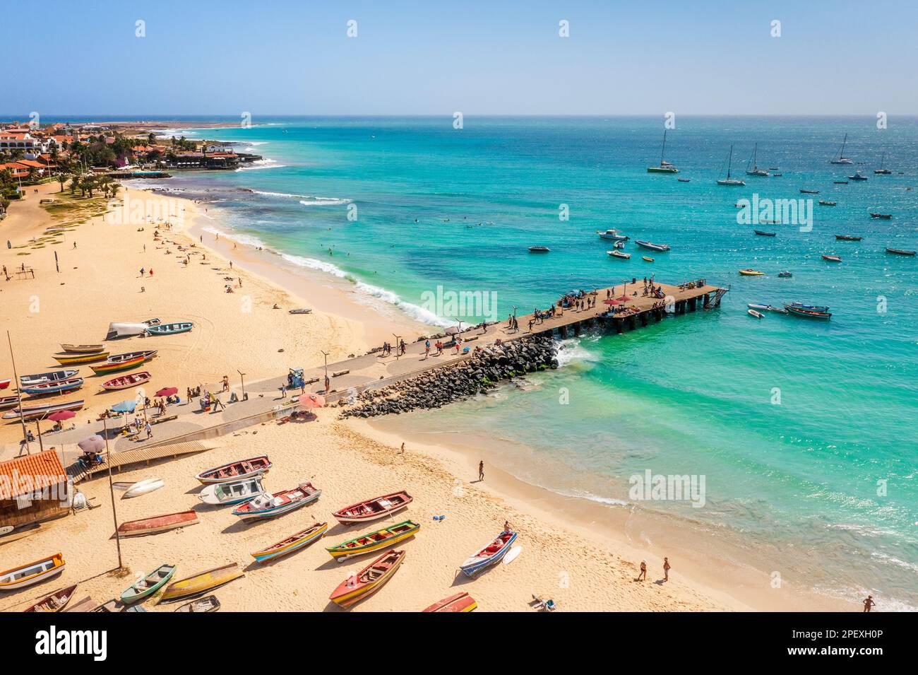 Pier and boats on turquoise water in city of Santa Maria, island of Sal ...