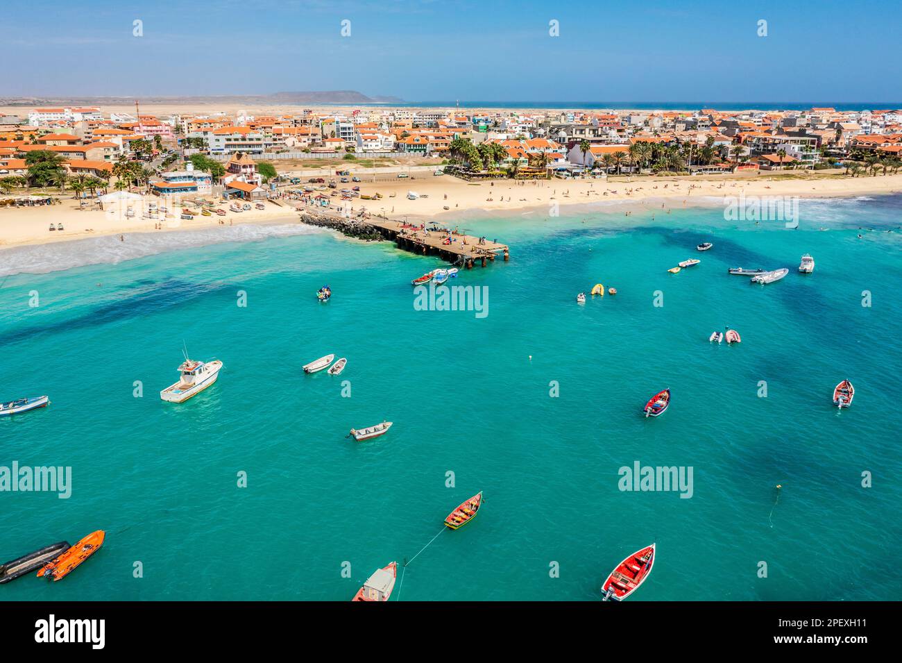Pier and boats on turquoise water in city of Santa Maria, island of Sal ...