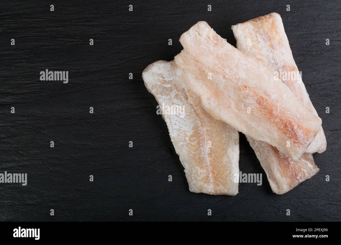 Frozen Fish on Black Plate, White Cod Fillet, Iced Hake Filet, Frozen ...