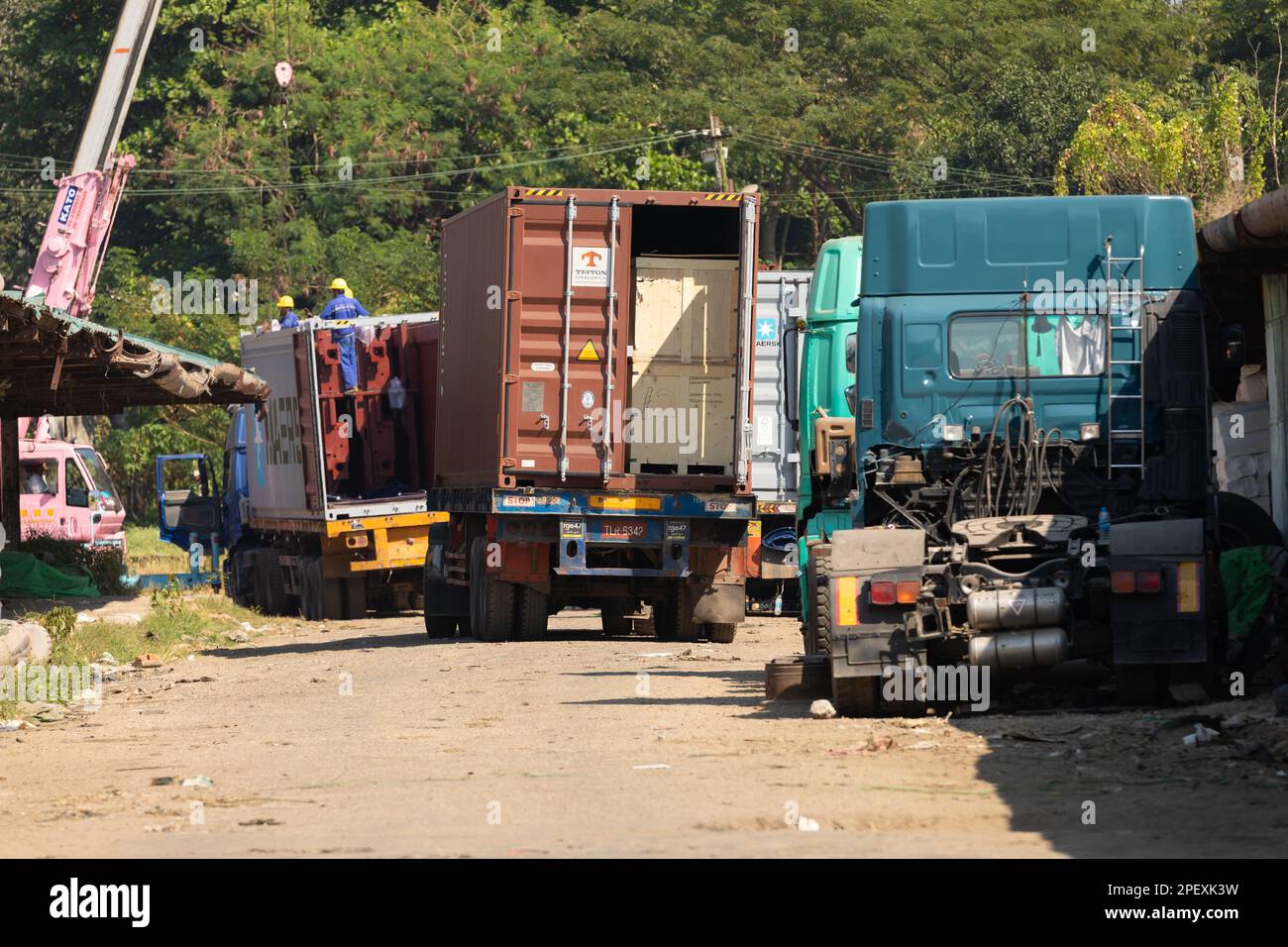 Yangon, Myanmar - Dec 19, 2019: Transport trucks unloading containers ...