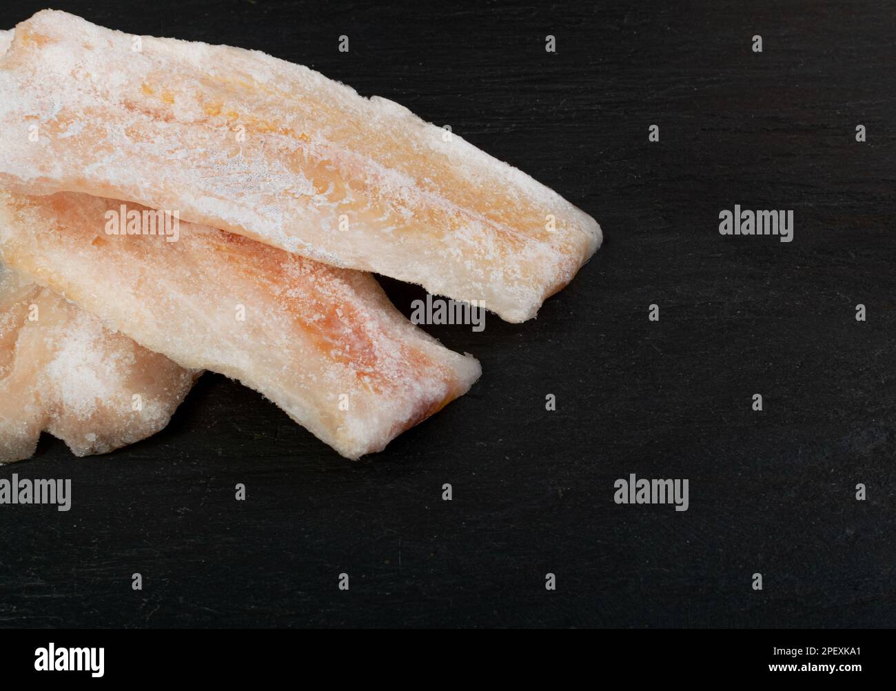 Frozen Fish on Black Plate, White Cod Fillet, Iced Hake Filet, Frozen ...