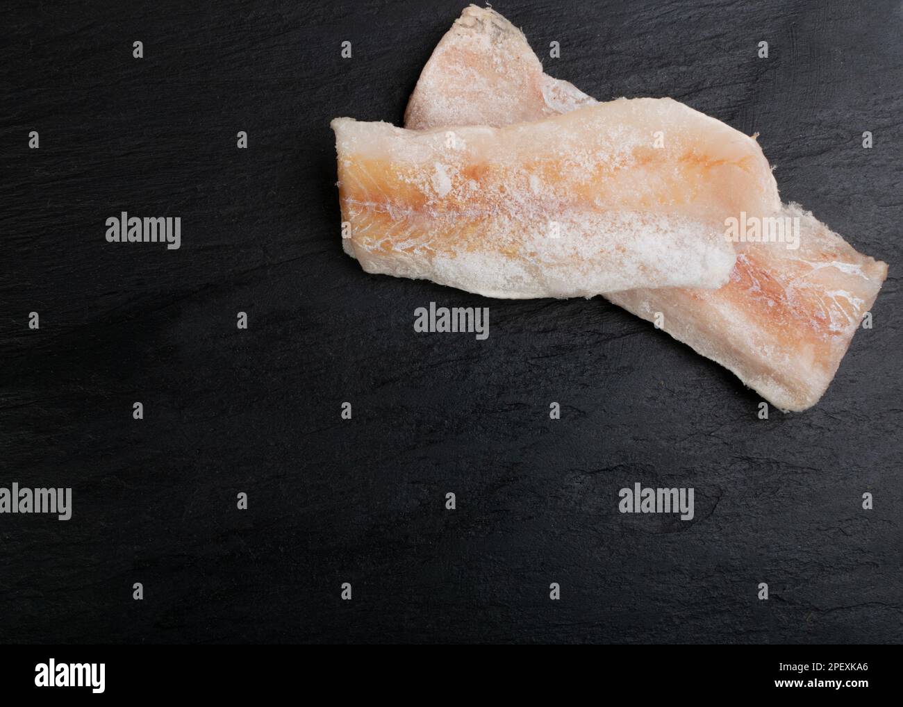Frozen Fish on Black Plate, White Cod Fillet, Iced Hake Filet, Frozen ...